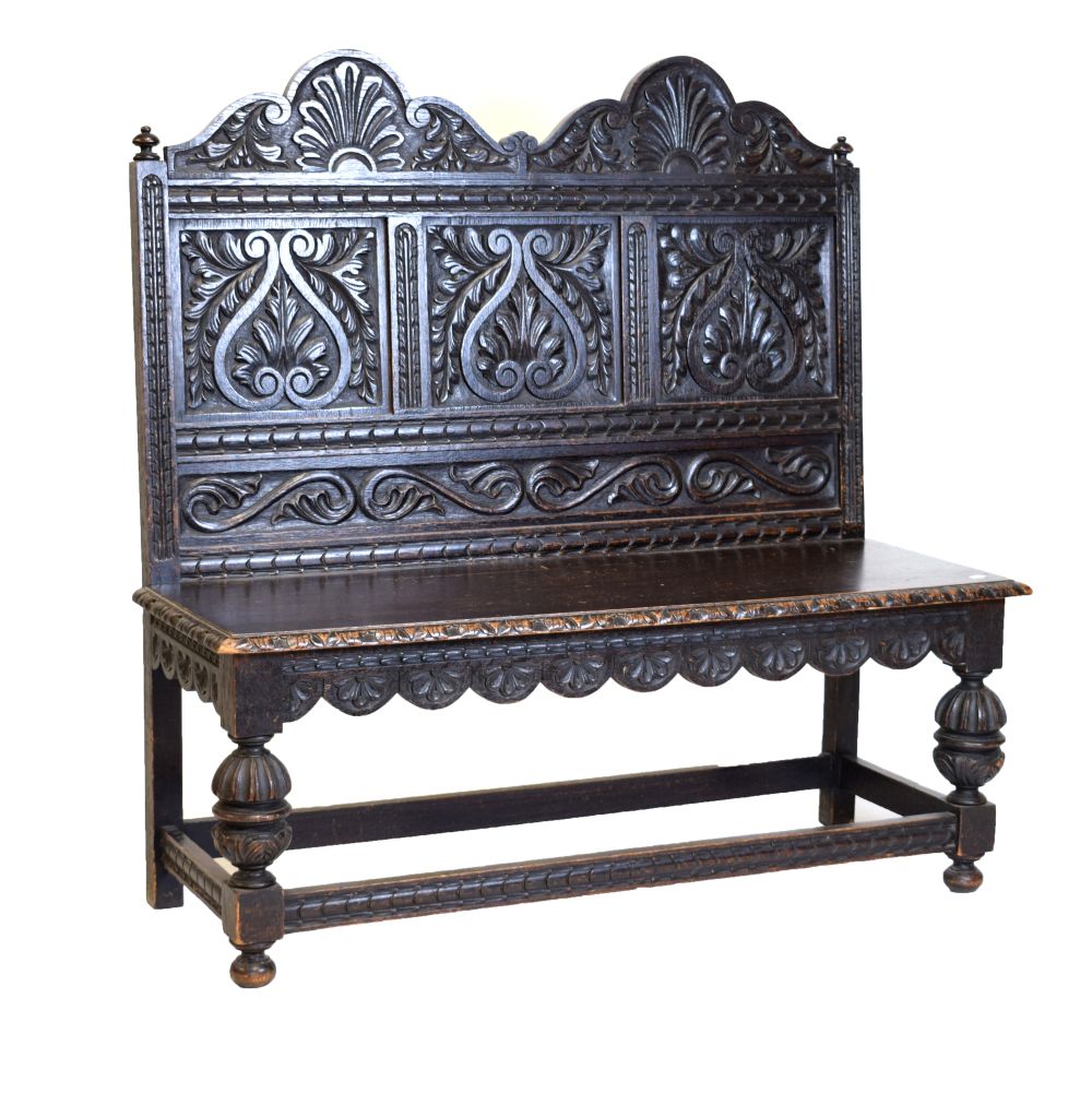 Lot 679 - Carved oak high back bench