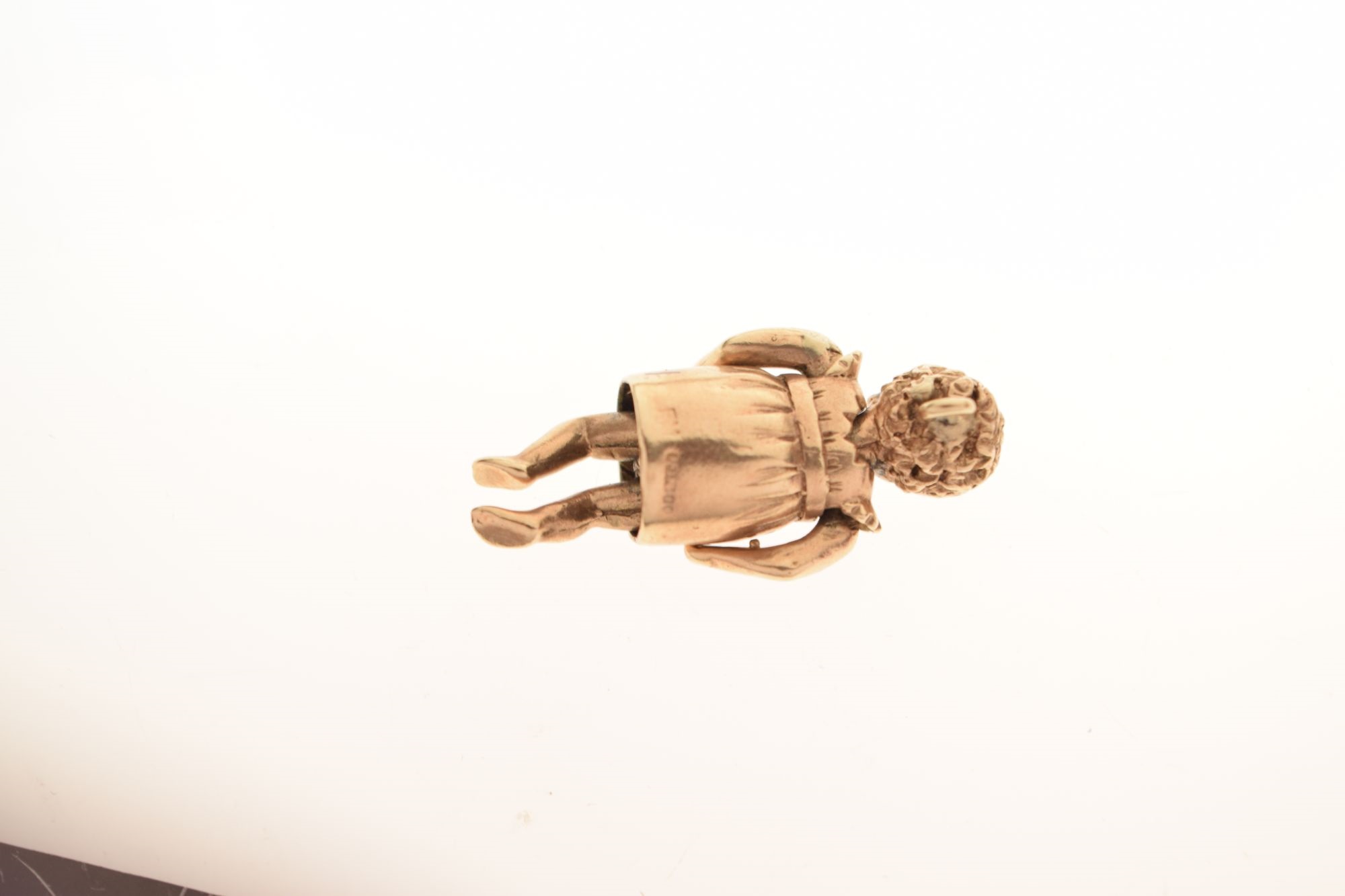 Lot 100 - 9ct gold articulated doll charm