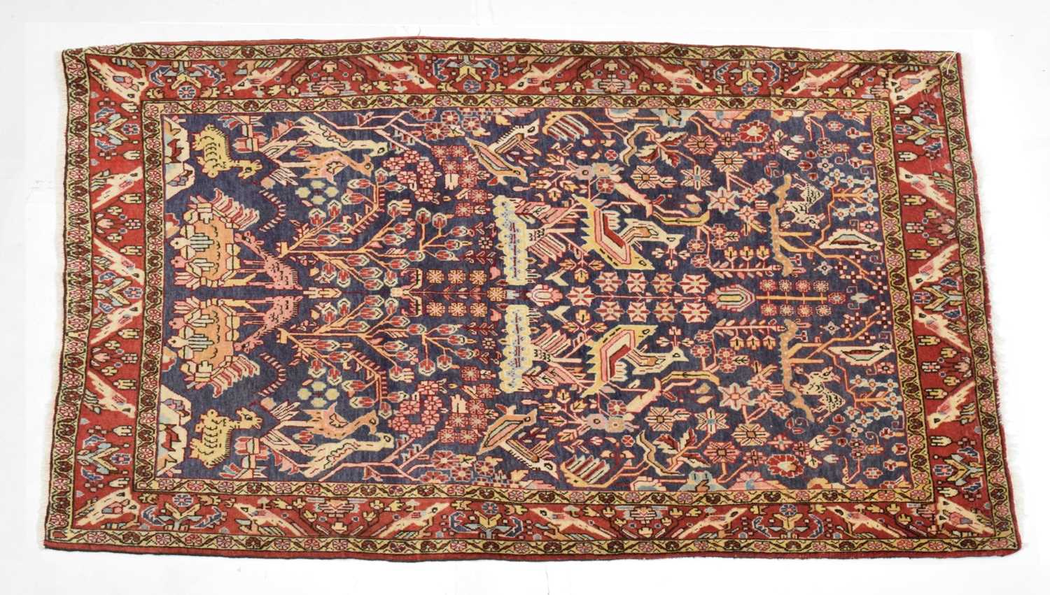 Lot 527 - Blue and red ground wool rug
