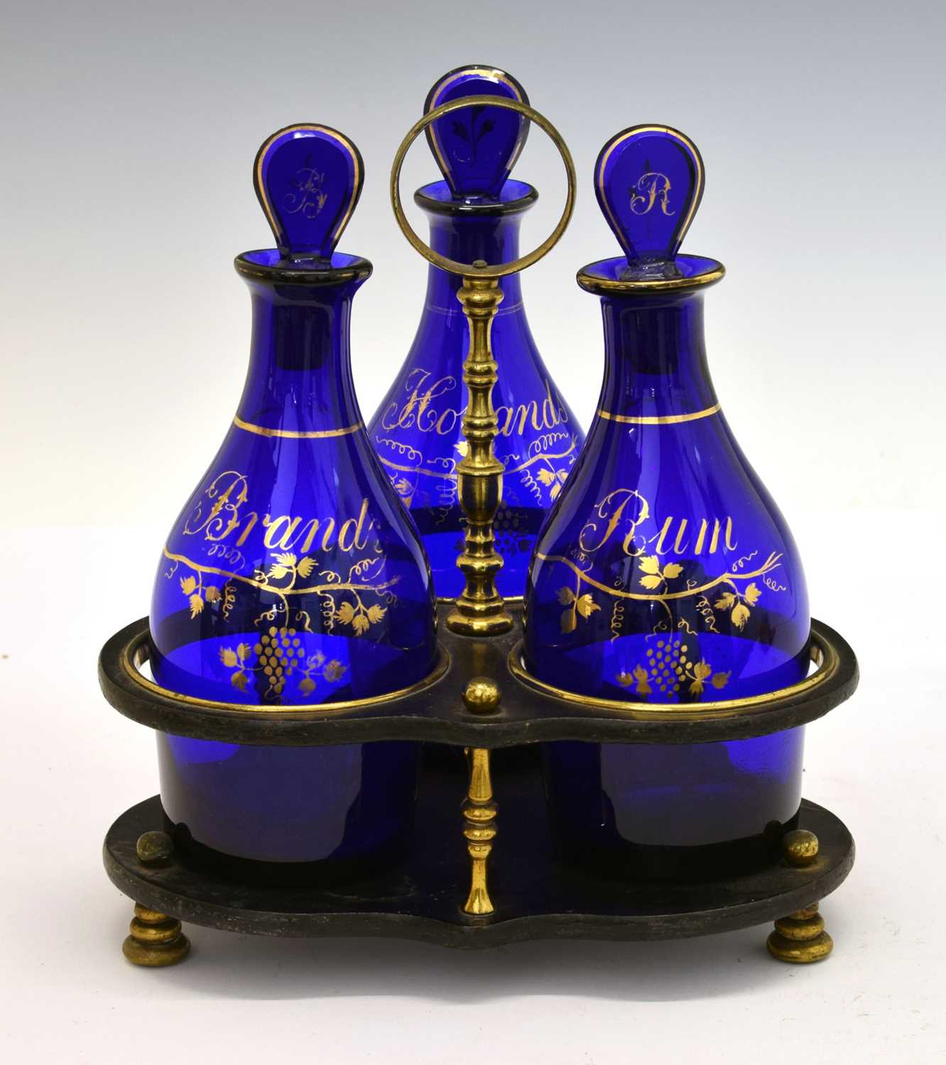 Lot 257 - Three-bottle decanter set and stand
