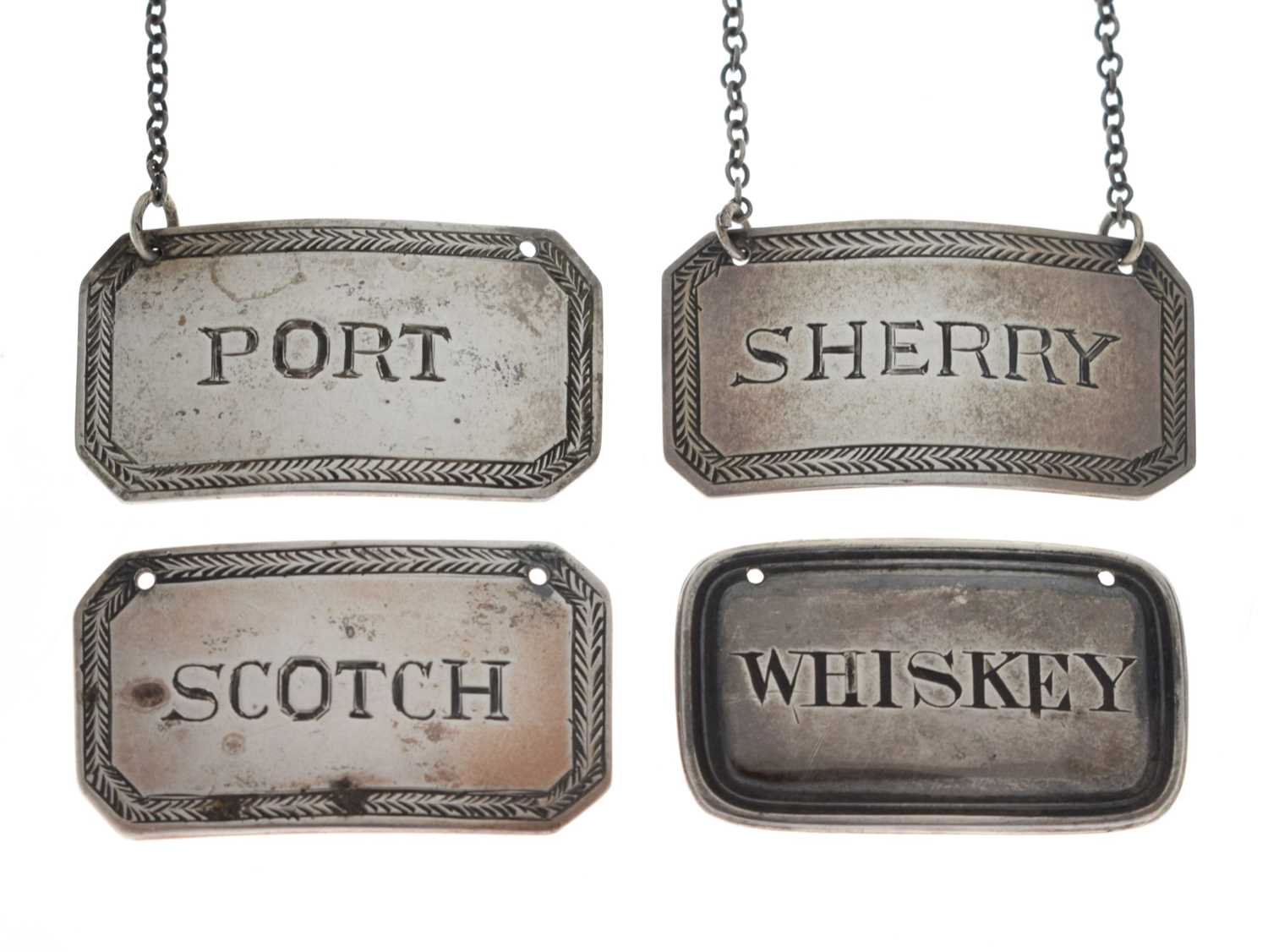 Lot 116 - Set of three white-metal decanter labels and