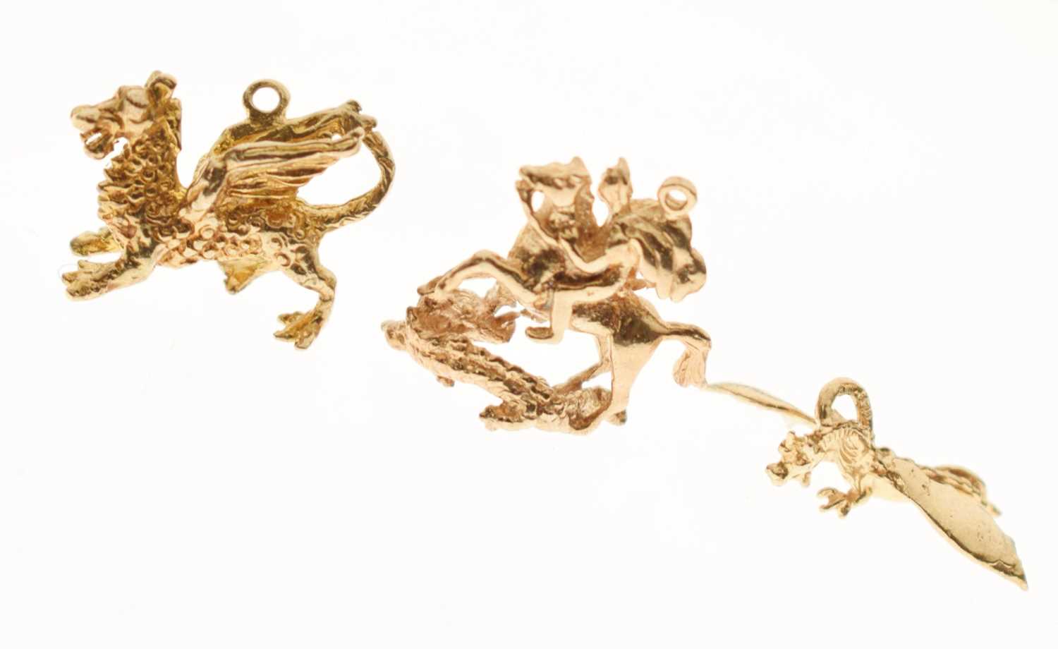 Lot 262 - Three 9ct gold charms - Dragons / St George