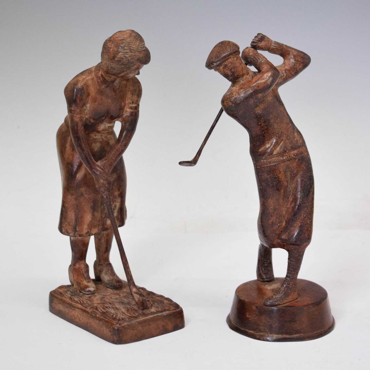 Lot 414 - Two patinated iron figures of golfers