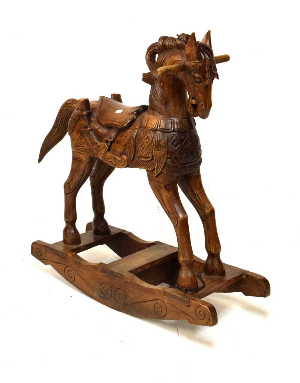 Lot 678 - Child's carved rocking horse with a fabric